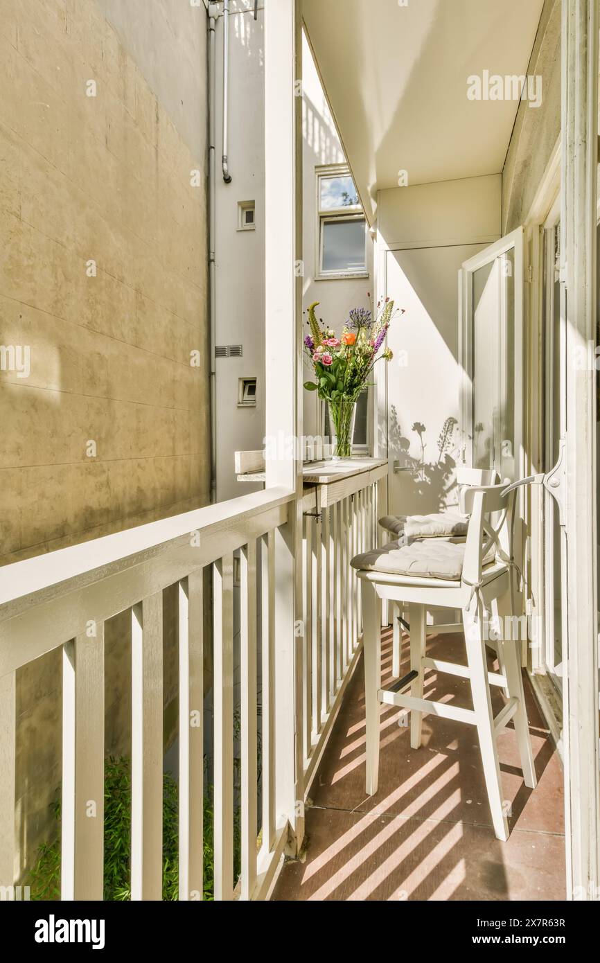 A quaint balcony showcasing a vase with colorful fresh flowers ...