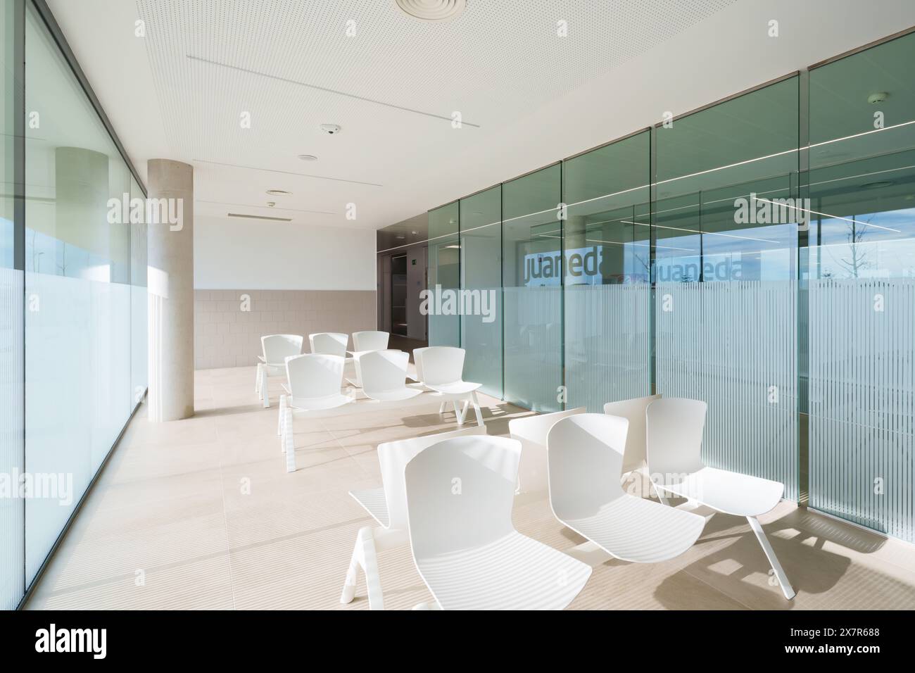A spacious and contemporary hospital waiting area flooded with natural ...