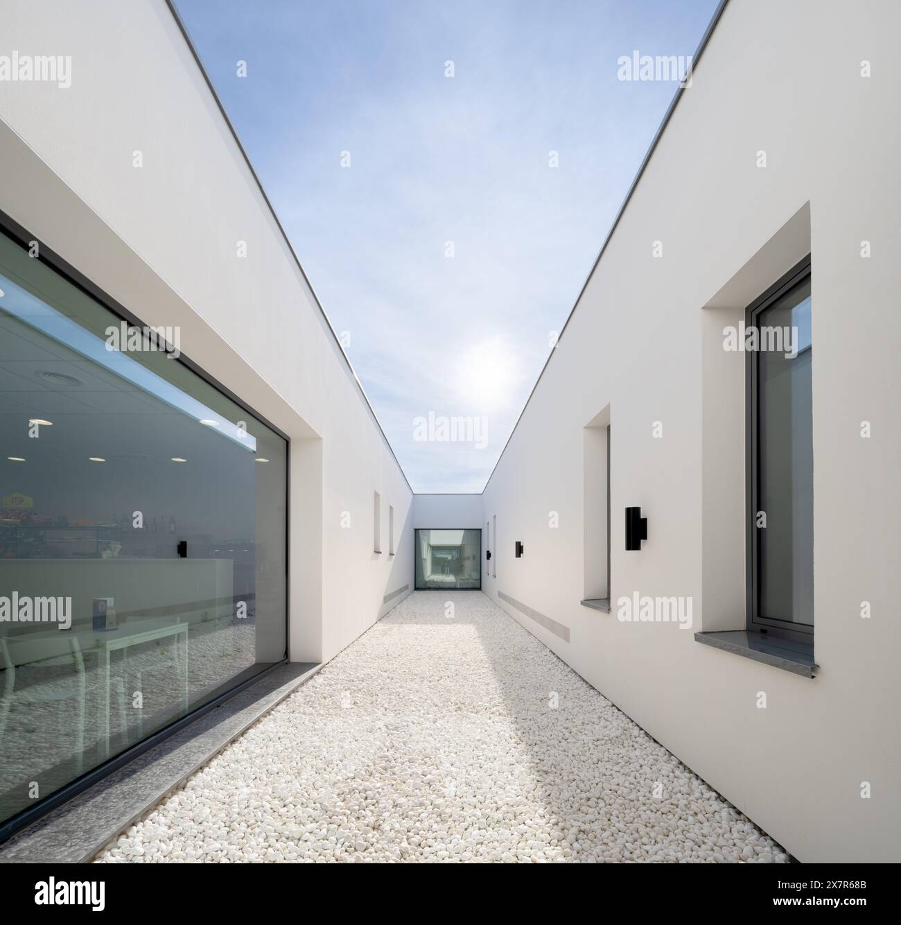 A contemporary hospital corridor flaunting a minimalist white-walled ...