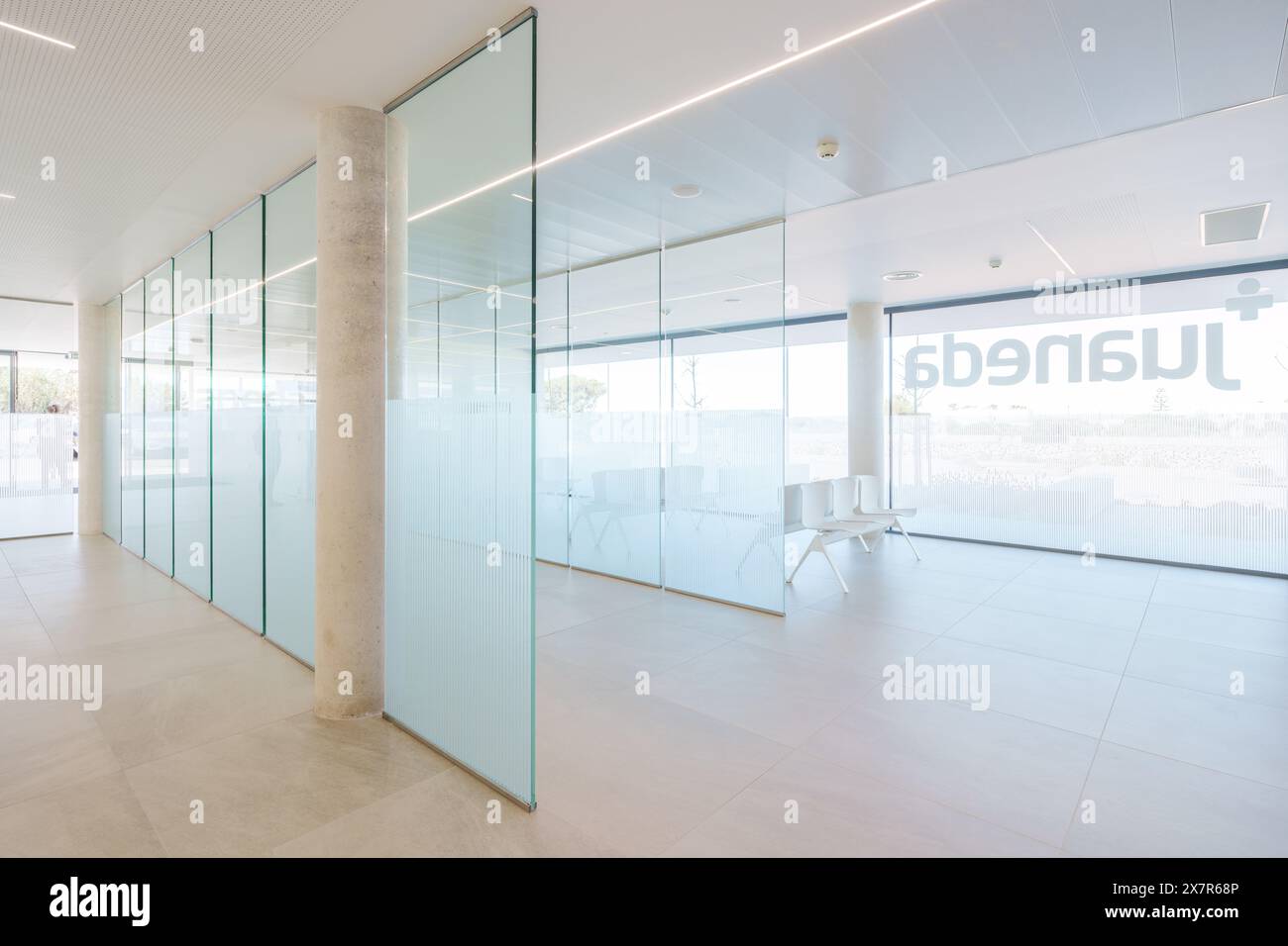 Bright and airy hospital lobby with clean lines, glass partitions, and ...