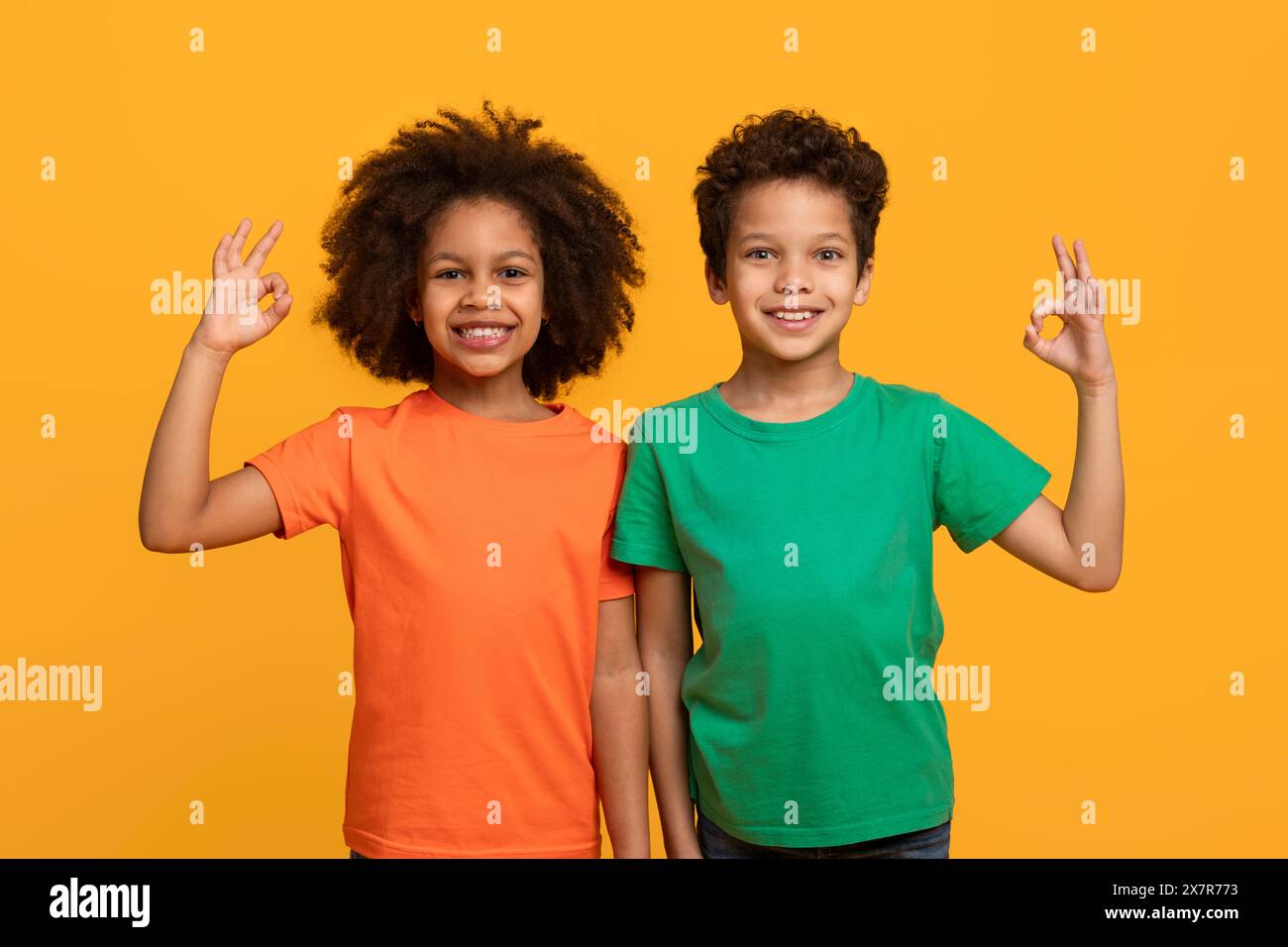 Two Children in Orange T-Shirts Making the OK Sign Stock Photo - Alamy