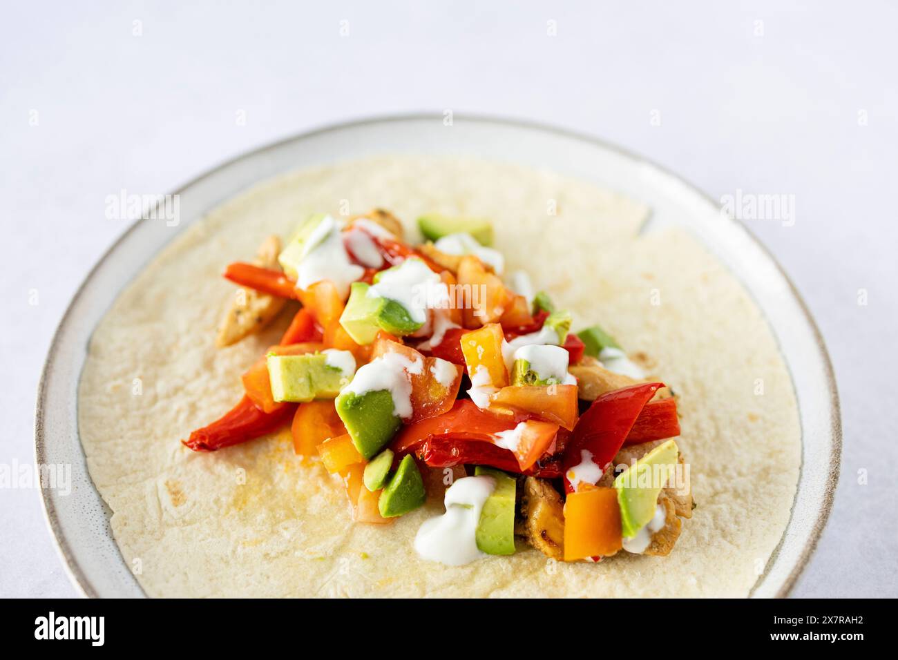 Chicken fajita with bell pepper, avocado and yogurt Stock Photo - Alamy