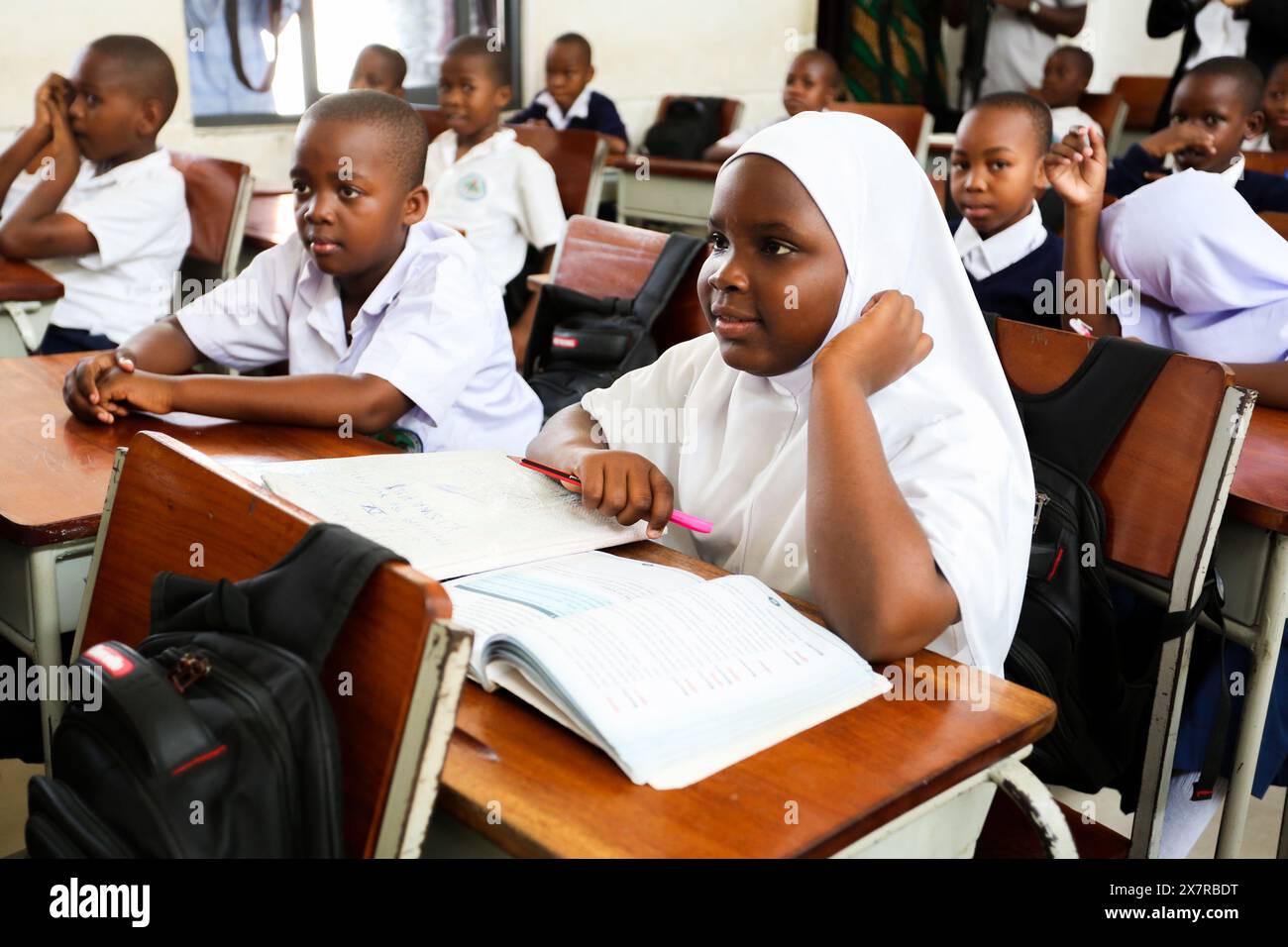 Dar Es Salaam, Tanzania. 20th May, 2024. Tanzanian students listen as ...
