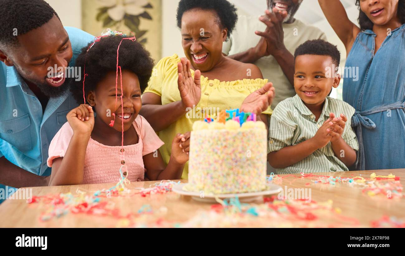 Multi-Generation Family Celebrating Granddaughter's Birthday At Home ...