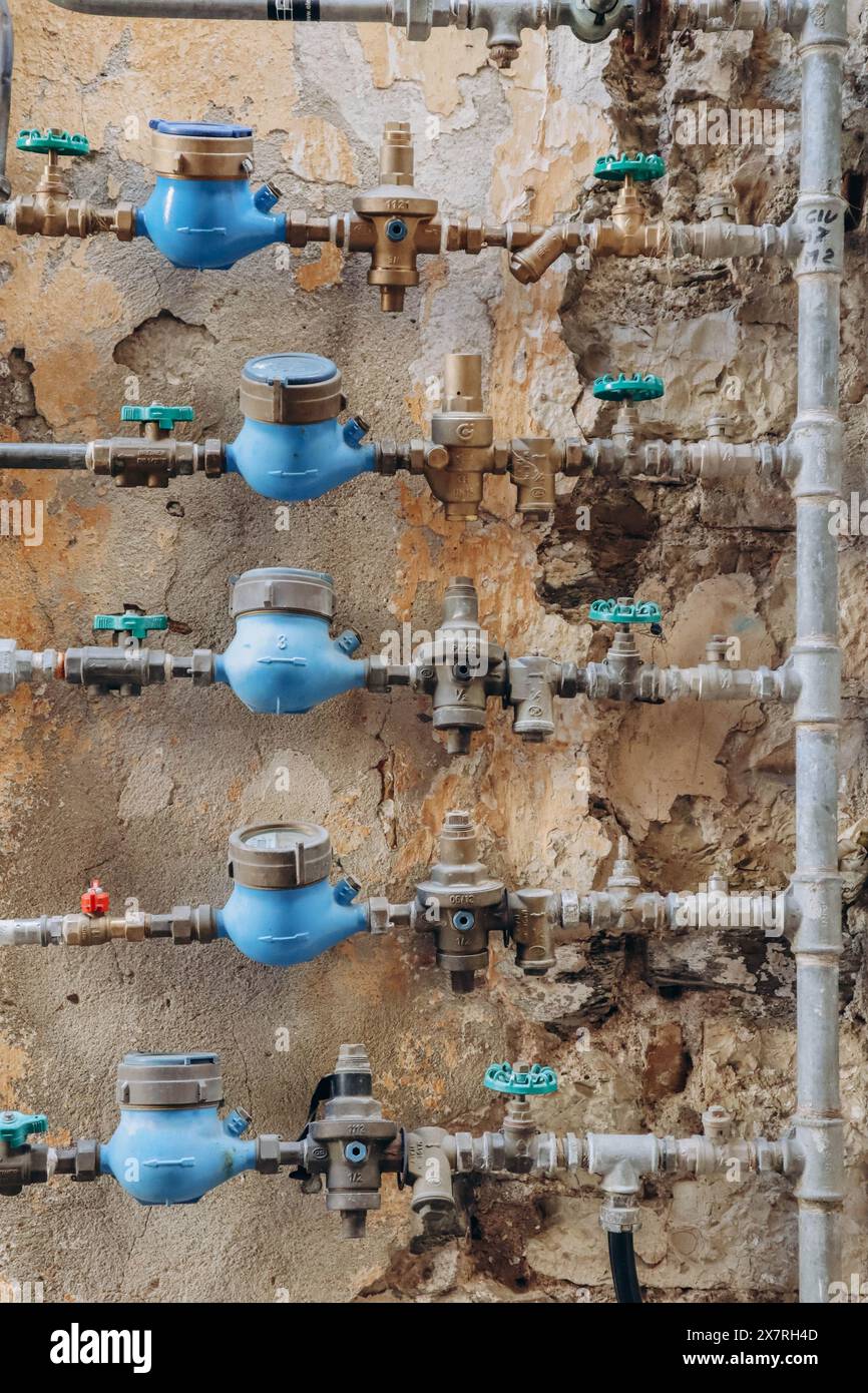 Water pipes with meters outside an old house in Italy Stock Photo - Alamy