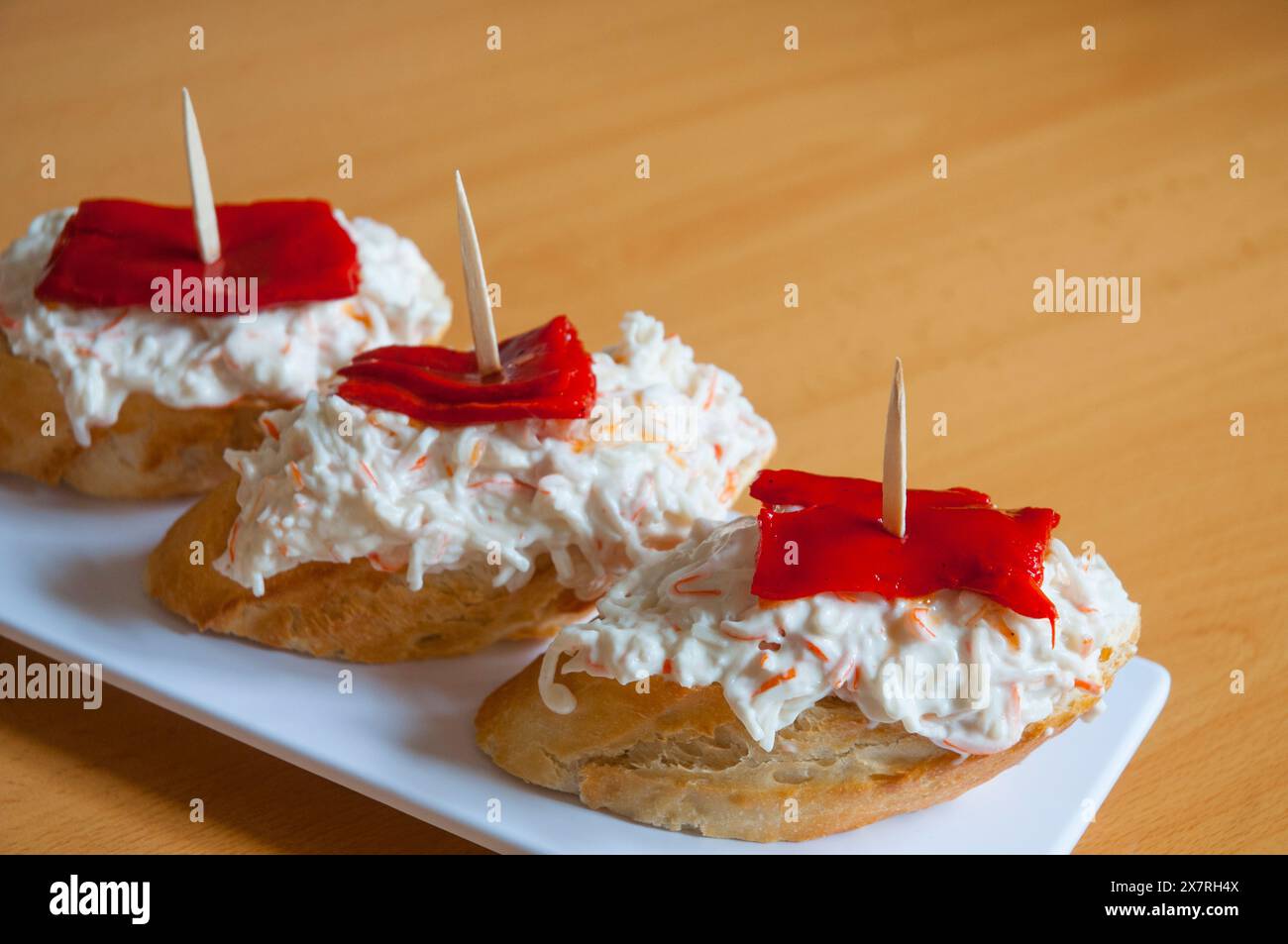 Spanish tapa: surimi salad with red pepper. Close view Stock Photo - Alamy