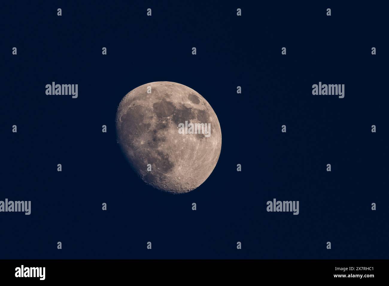 A partial lunar sphere with visible craters moves across the sky after ...