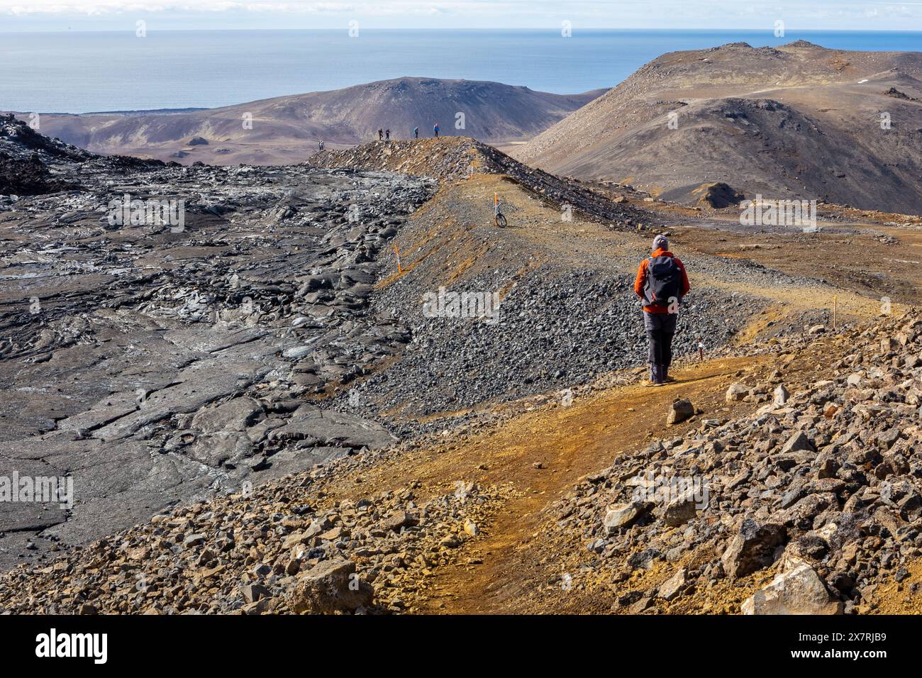 Male tourist walking at Fagradalsfjall volcano lava field, frozen ...