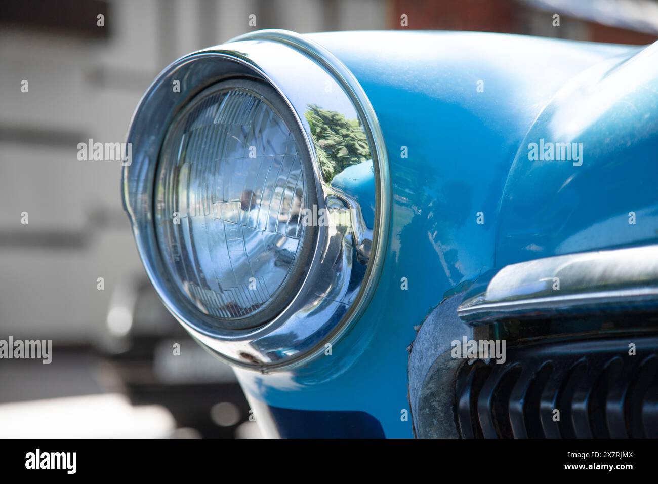 Old round headlight close up view . front light details blue car ...
