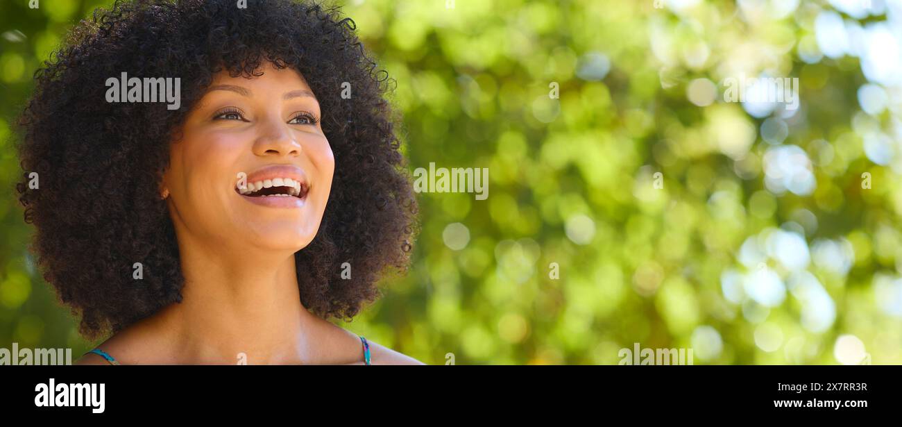 Head And Shoulders Portrait Of Smiling Woman Outside Relaxing In ...