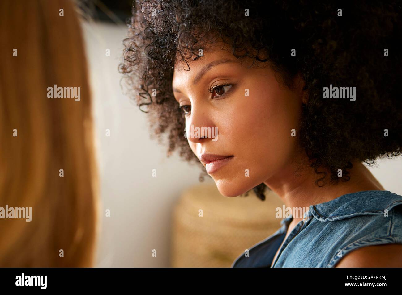 Close Up Shot Of Two Female Friends Having Serious Conversation At Home ...