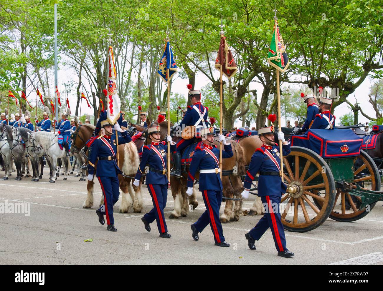 Four soldiers of the Royal Guard carrying military colours at a public ...