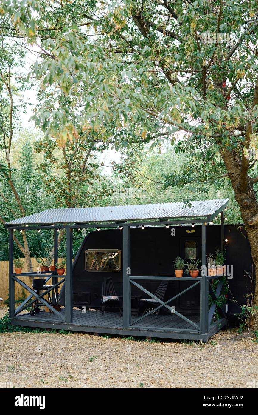 A delightful scene of a small shed nestled under a tree, surrounded by ...