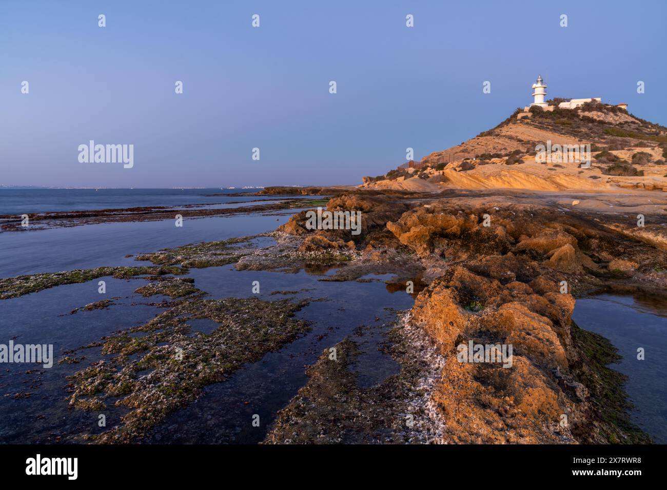 A view of the Cabo de la Huerta lighthouse at sunrise Stock Photo - Alamy