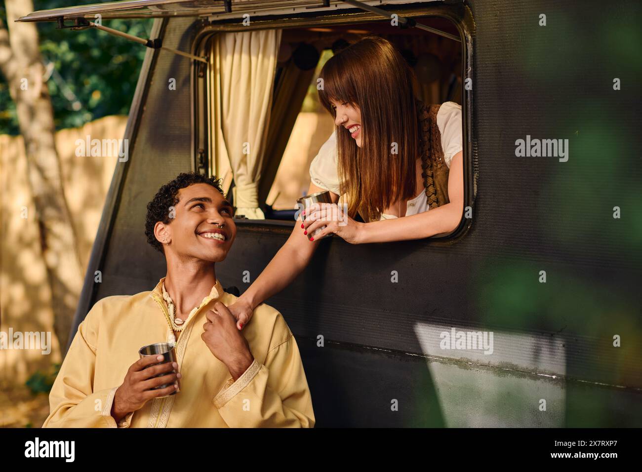 A man and woman sit together on a train, deep in conversation, as they ...
