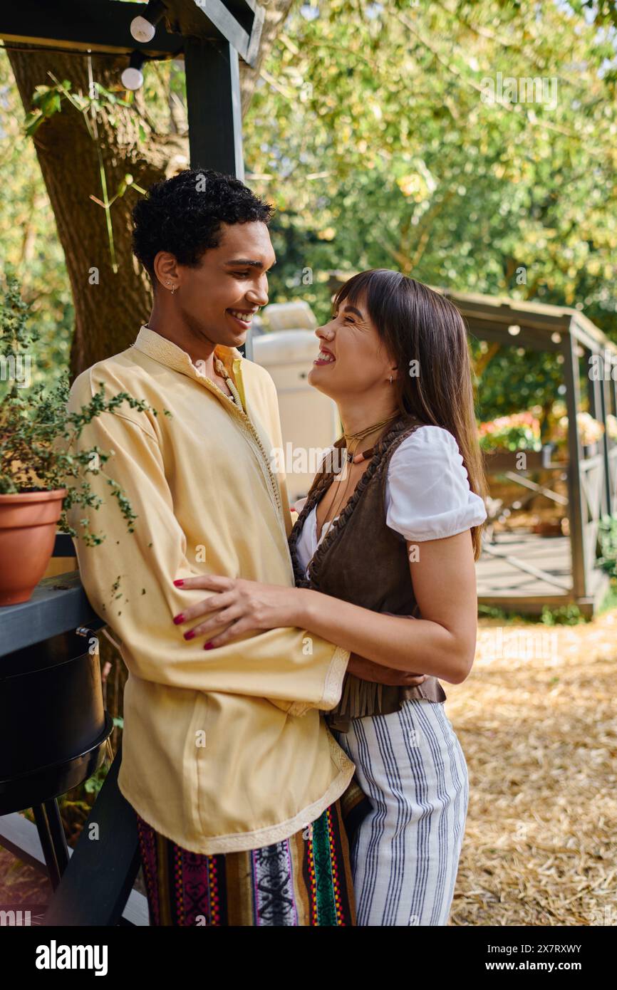 An interracial couple standing together, enjoying a romantic getaway in ...