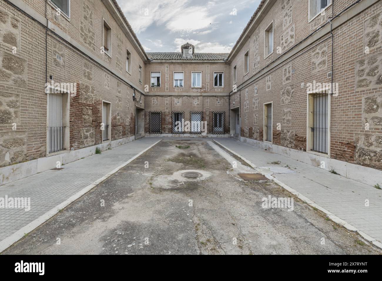 Interior patio of a two-story monumental building between gardens of ...