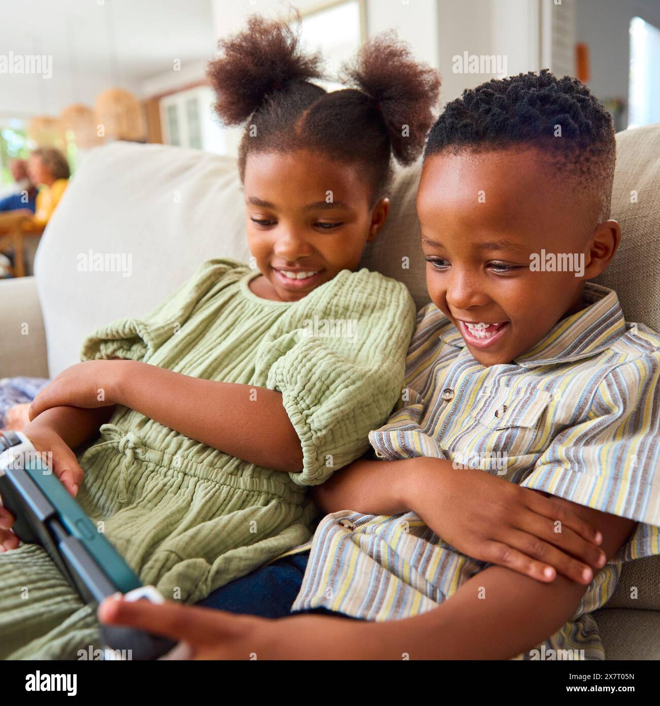 Boy And Girl Playing With Handheld Gaming Device At Home With Multi ...