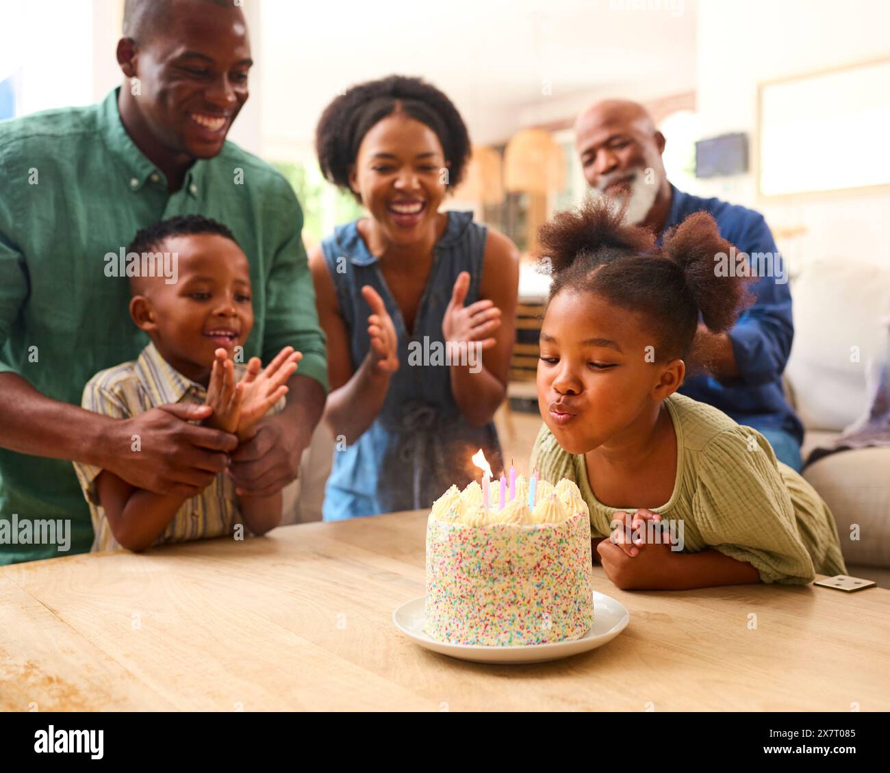 Multi-Generation Family Celebrating Granddaughter's Birthday At Home ...
