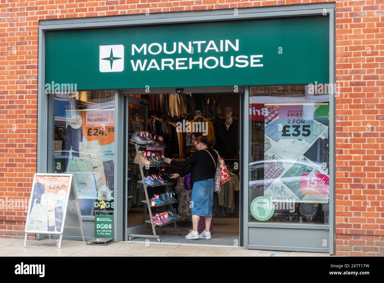 Mountain Warehouse shop selling outdoor kit and clothes with customers ...