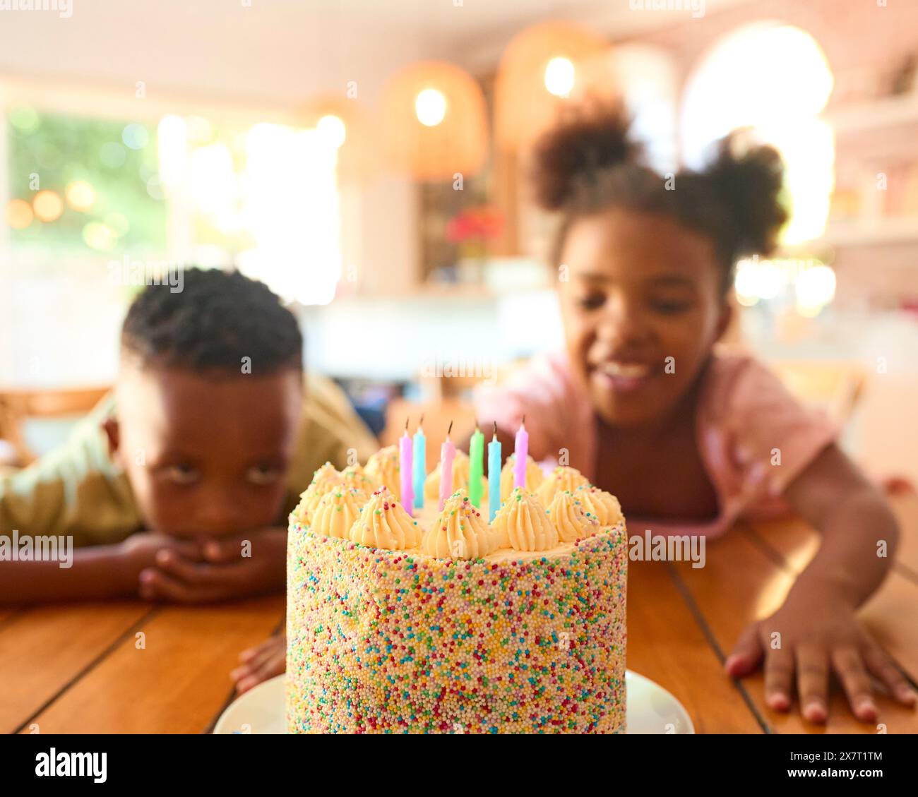 Two Children Looking Hungrily At Tasty Birthday Cake On Table For Party ...