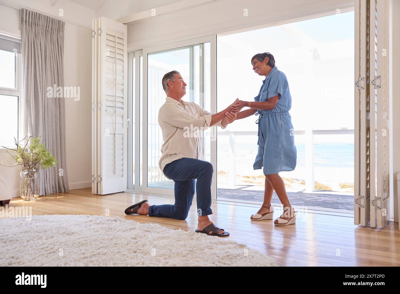 Mature Couple With Man Proposing Marriage Kneeling And Giving Woman