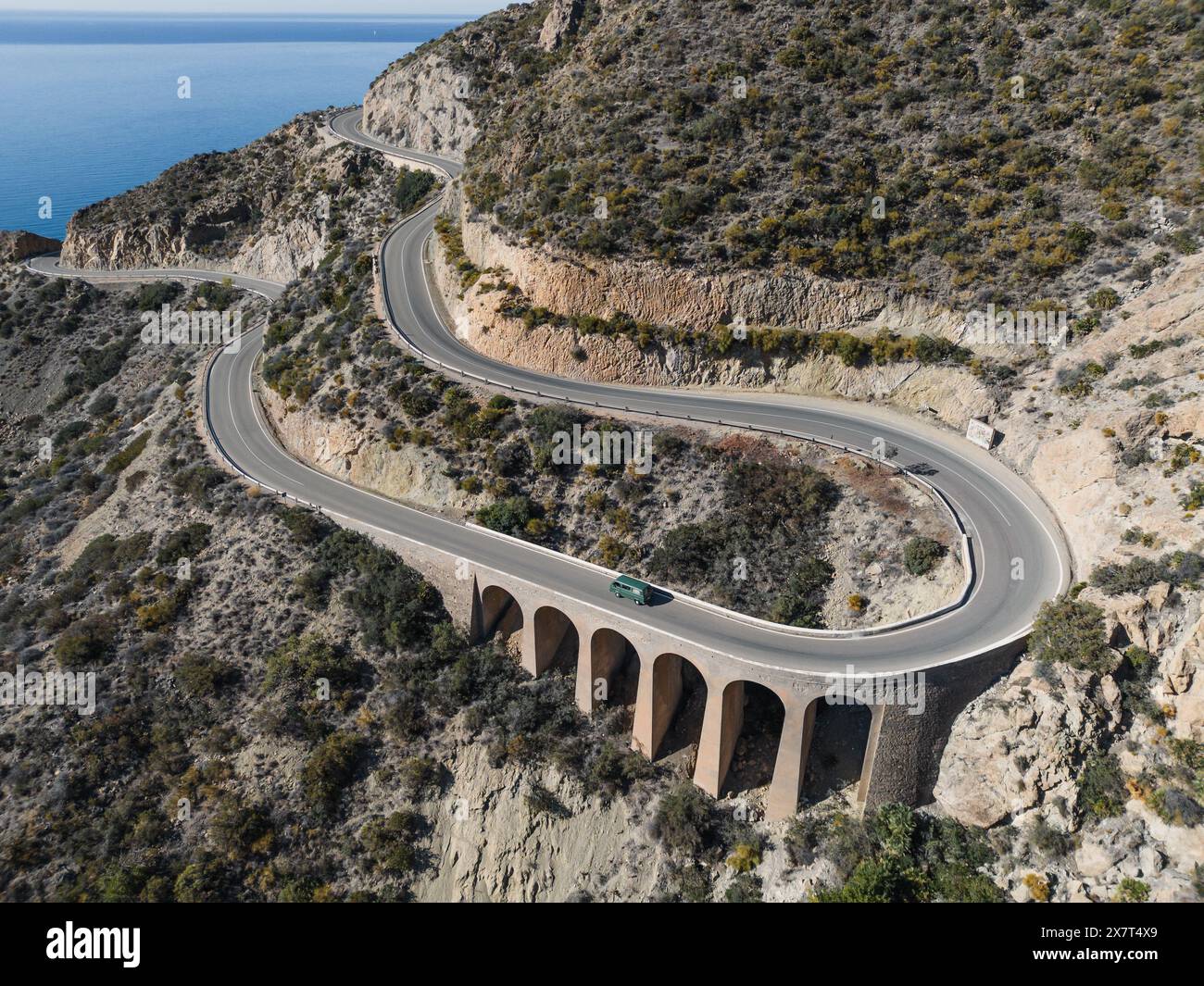 Vintage van driving on mountain curve road aerial view Stock Photo - Alamy