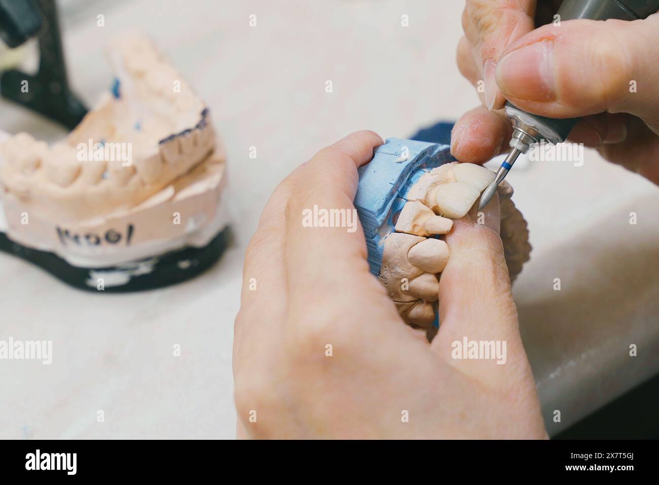 Close-up of dental technician holding toothbrush, focusing on ...
