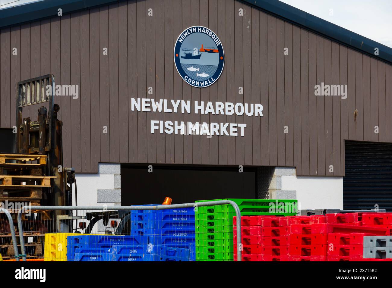 Newlyn harbour fish market building with colourful crates outside ...