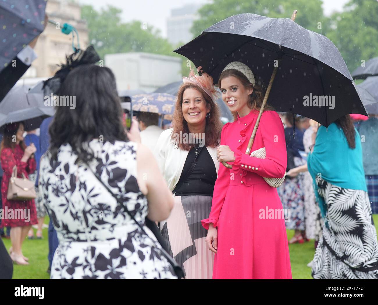 Princess Beatrice (right) poses for a photograph with a guest during ...