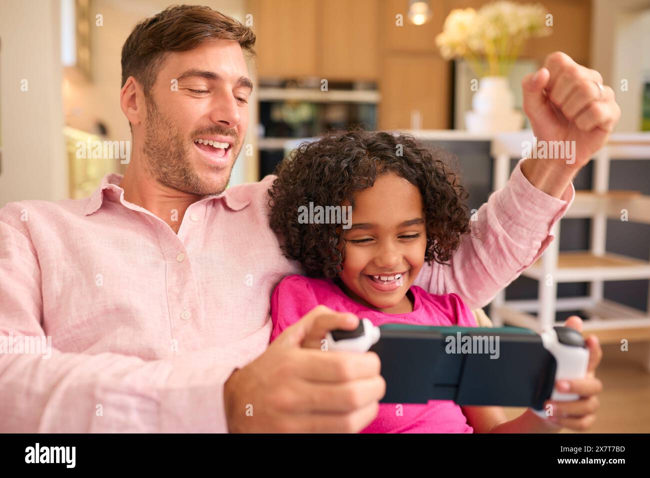 Multi Racial Family With Father And Daughter Playing On Handheld Gaming ...