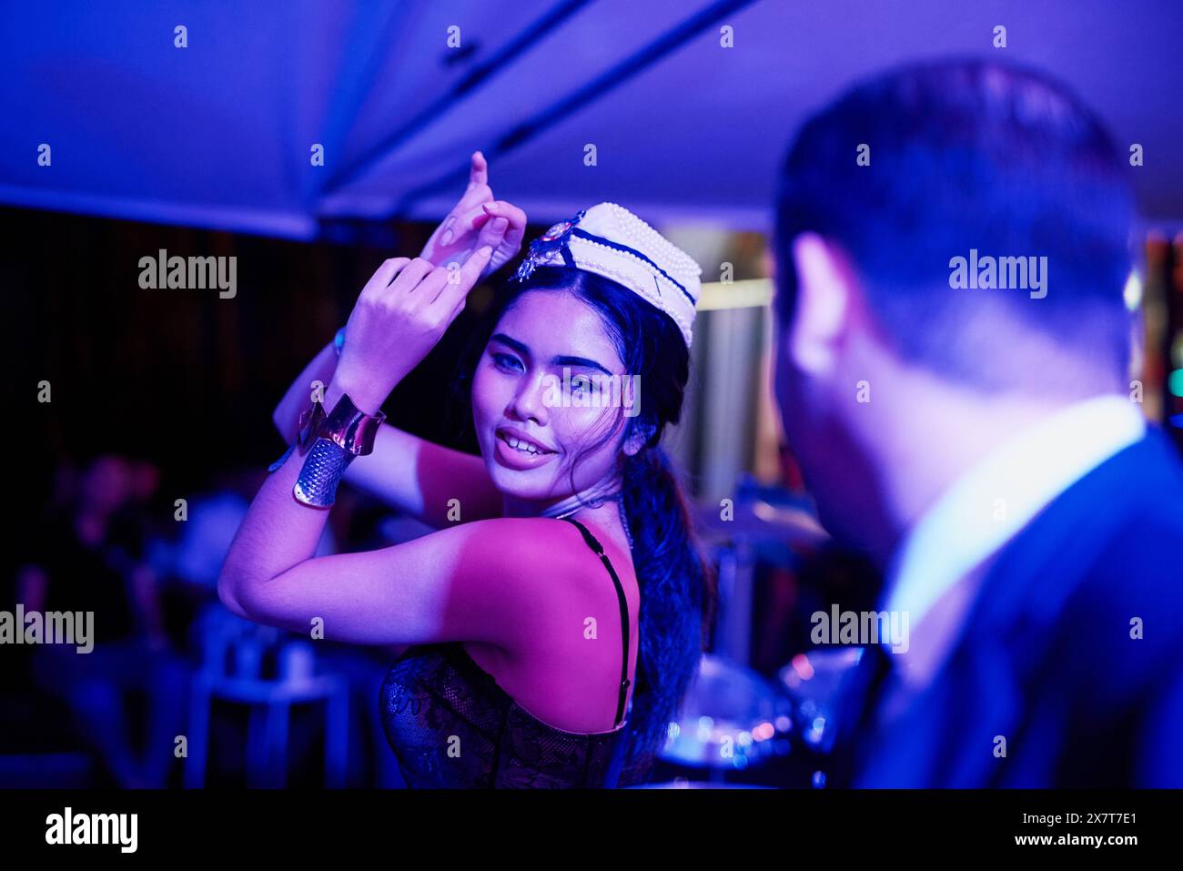 Music, dancing and Asian woman in nightclub with lights at disco event ...