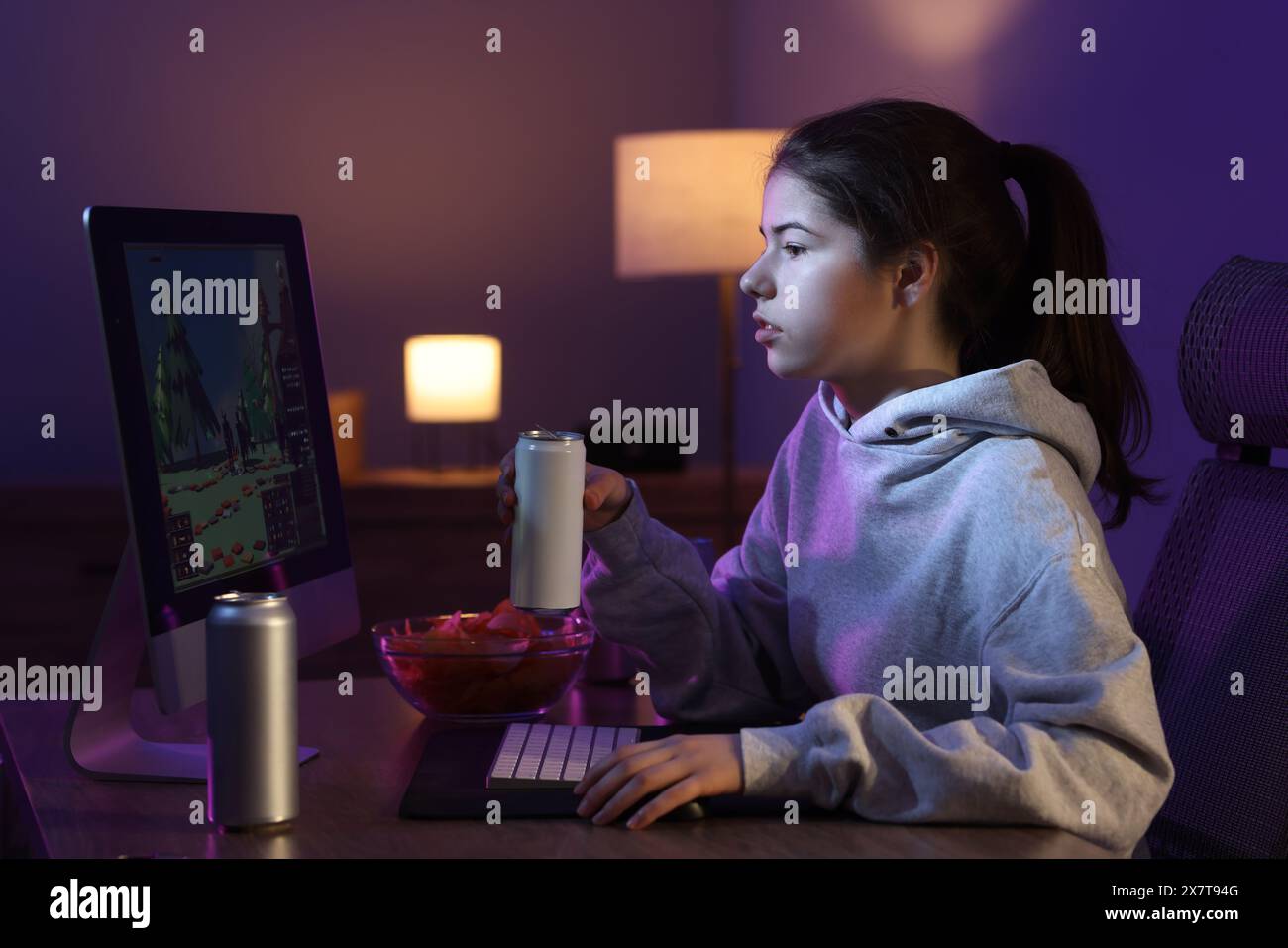 Girl with energy drink playing computer game at home Stock Photo - Alamy