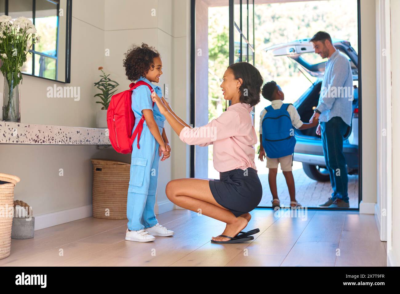 Family At Home With Parents Getting Children Ready To Leave House And ...