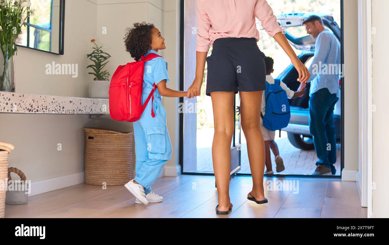 Family At Home With Parents Getting Children Ready To Leave House And ...