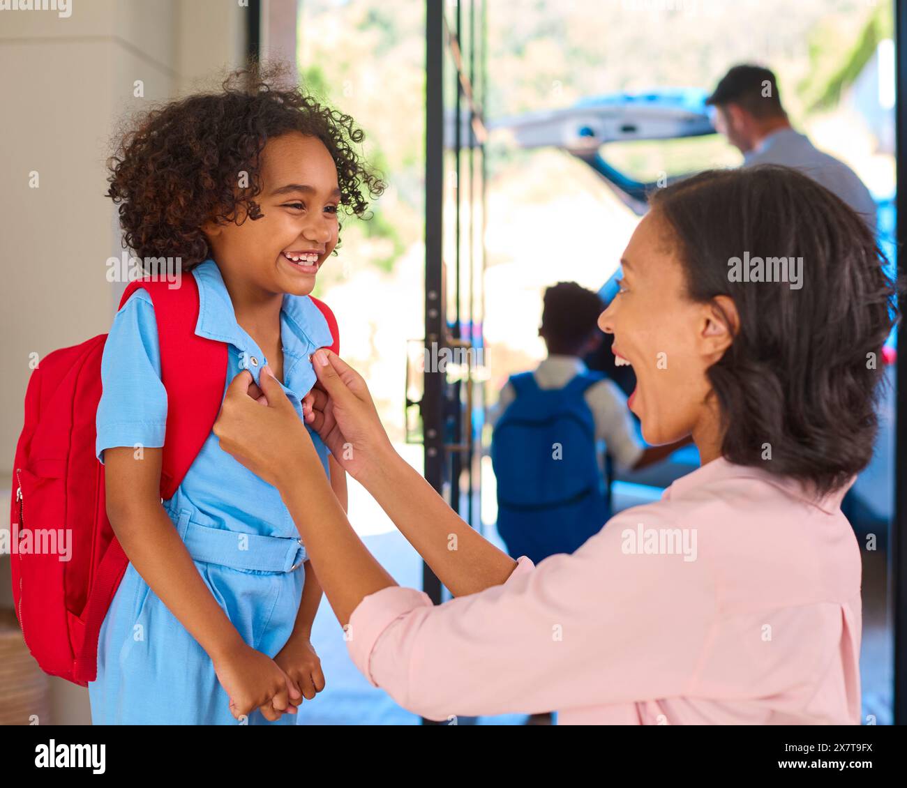 Family At Home With Parents Getting Children Ready To Leave House And ...