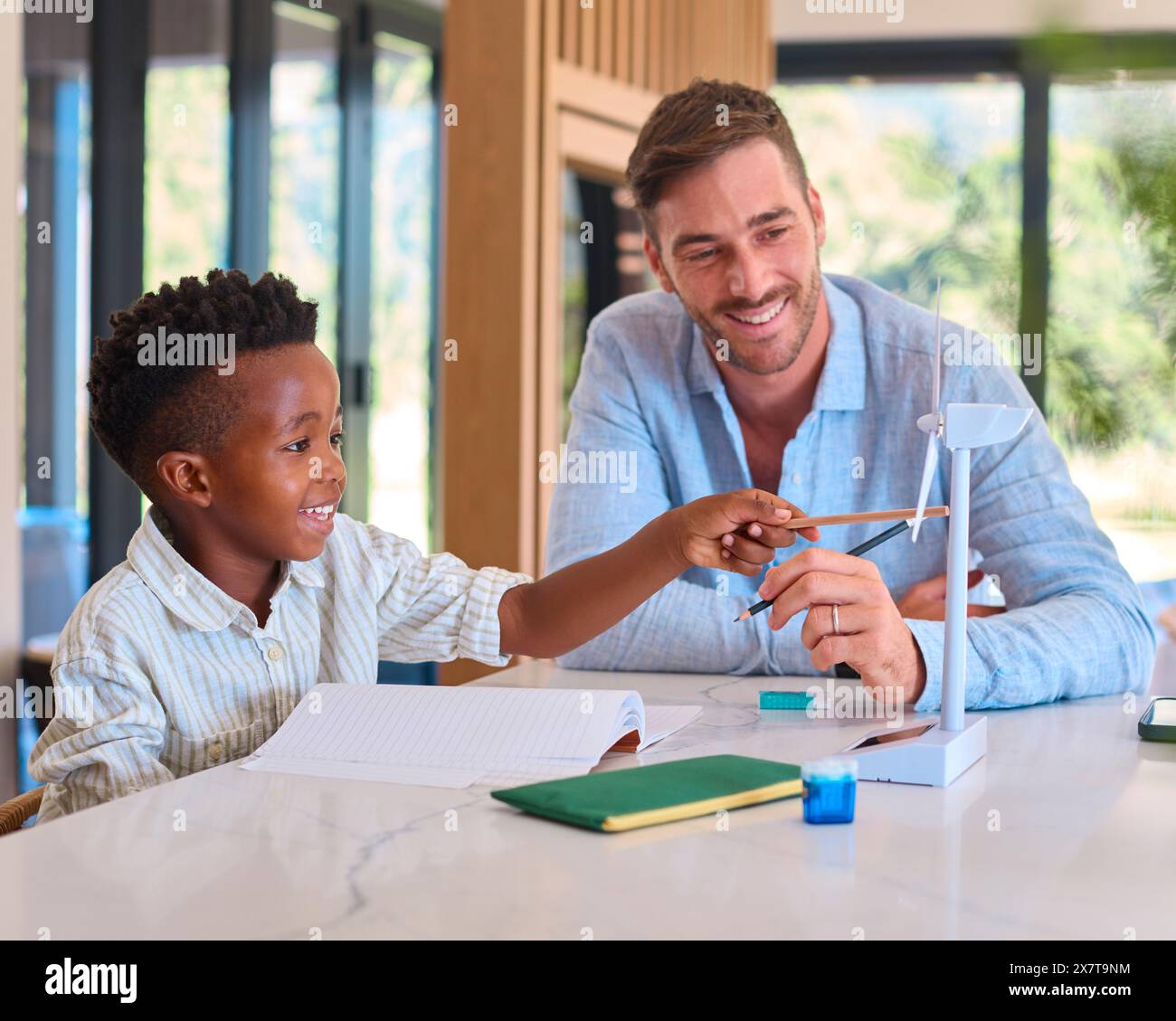 Multi Racial Family With Father And Son Doing Homework On Green Energy ...