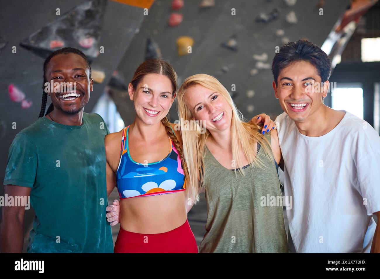 Portrait Of Climbers And Instructors Standing By Climbing Wall In ...