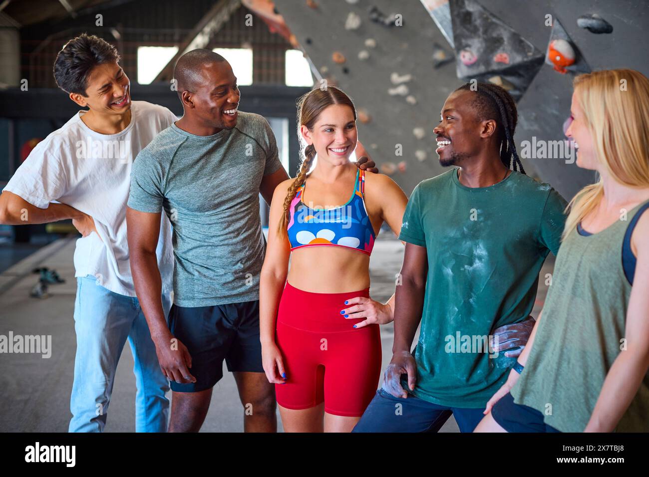 Group Of Climbers And Instructors Standing By Climbing Wall In Indoor ...