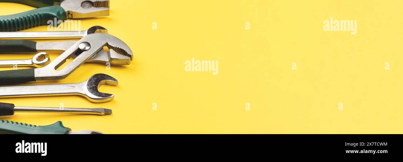 Work tools on bright yellow background banner. Panoramic web header ...