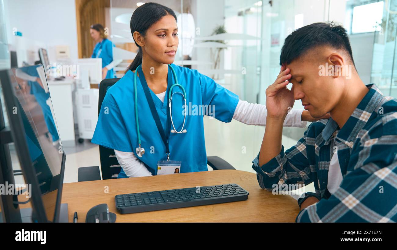 Female Doctor Wearing Scrubs At Hospital Appointment Giving Bad News To ...