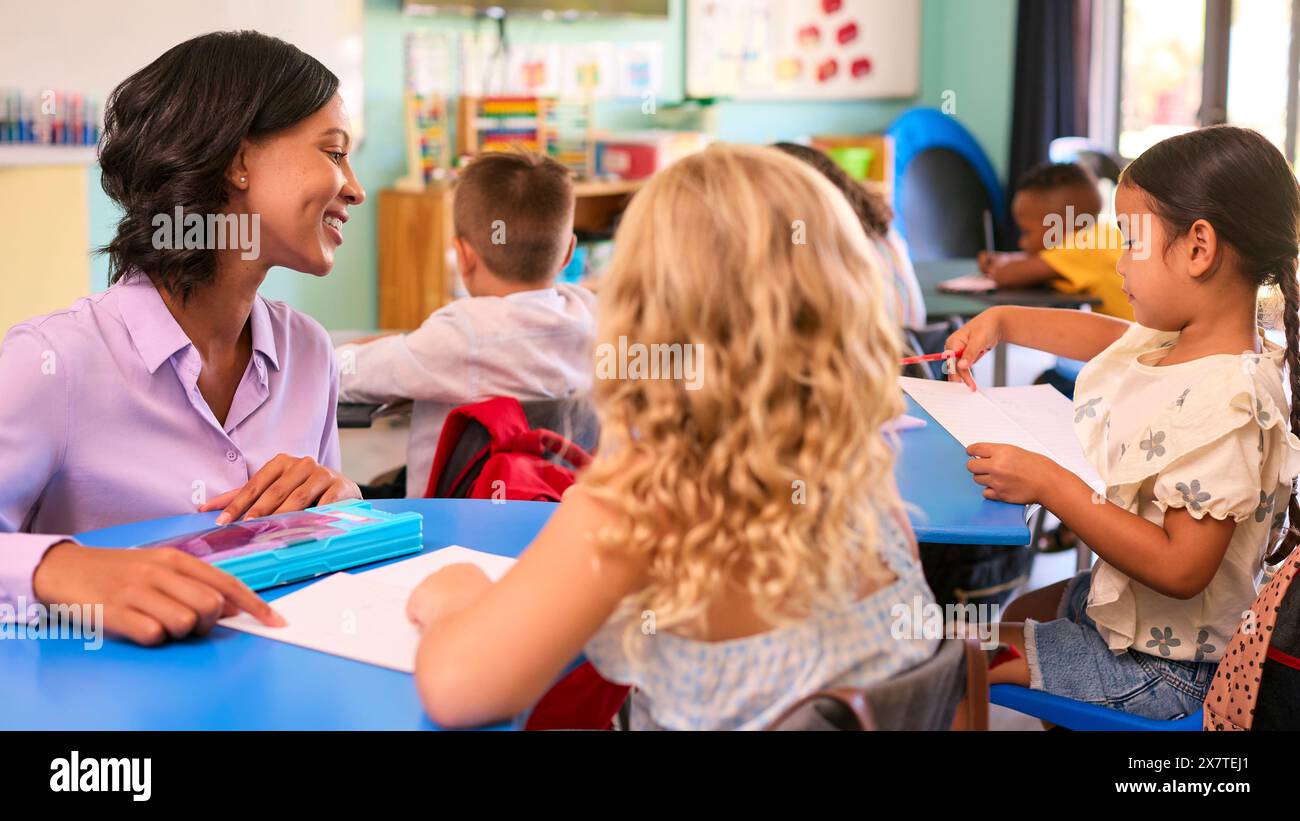 6 primary students working together hi-res stock photography and images ...