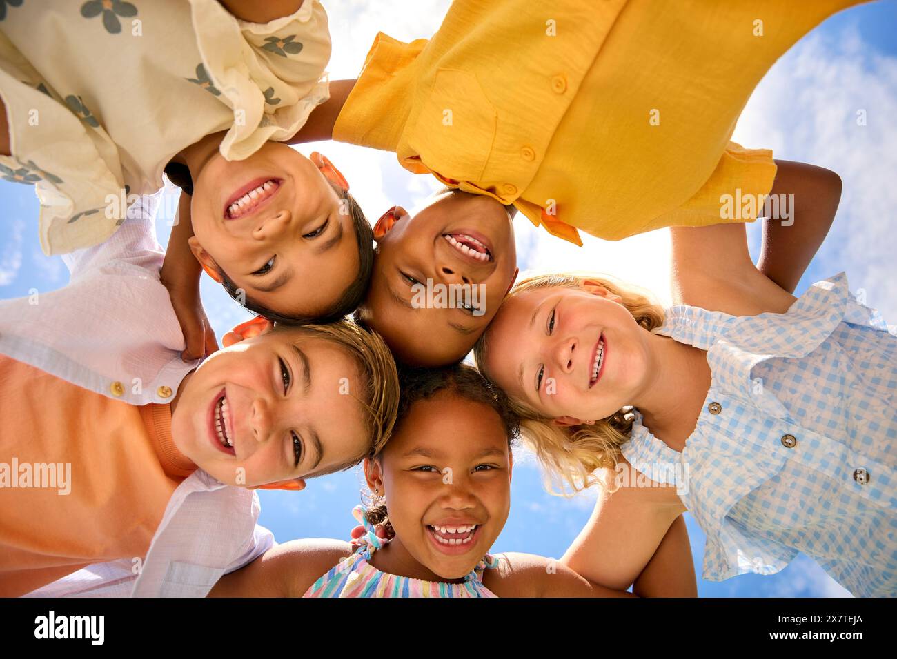 Group Of Multi-Cultural Children Friends Linking Arms Looking Down Into Camera Stock Photo - Alamy