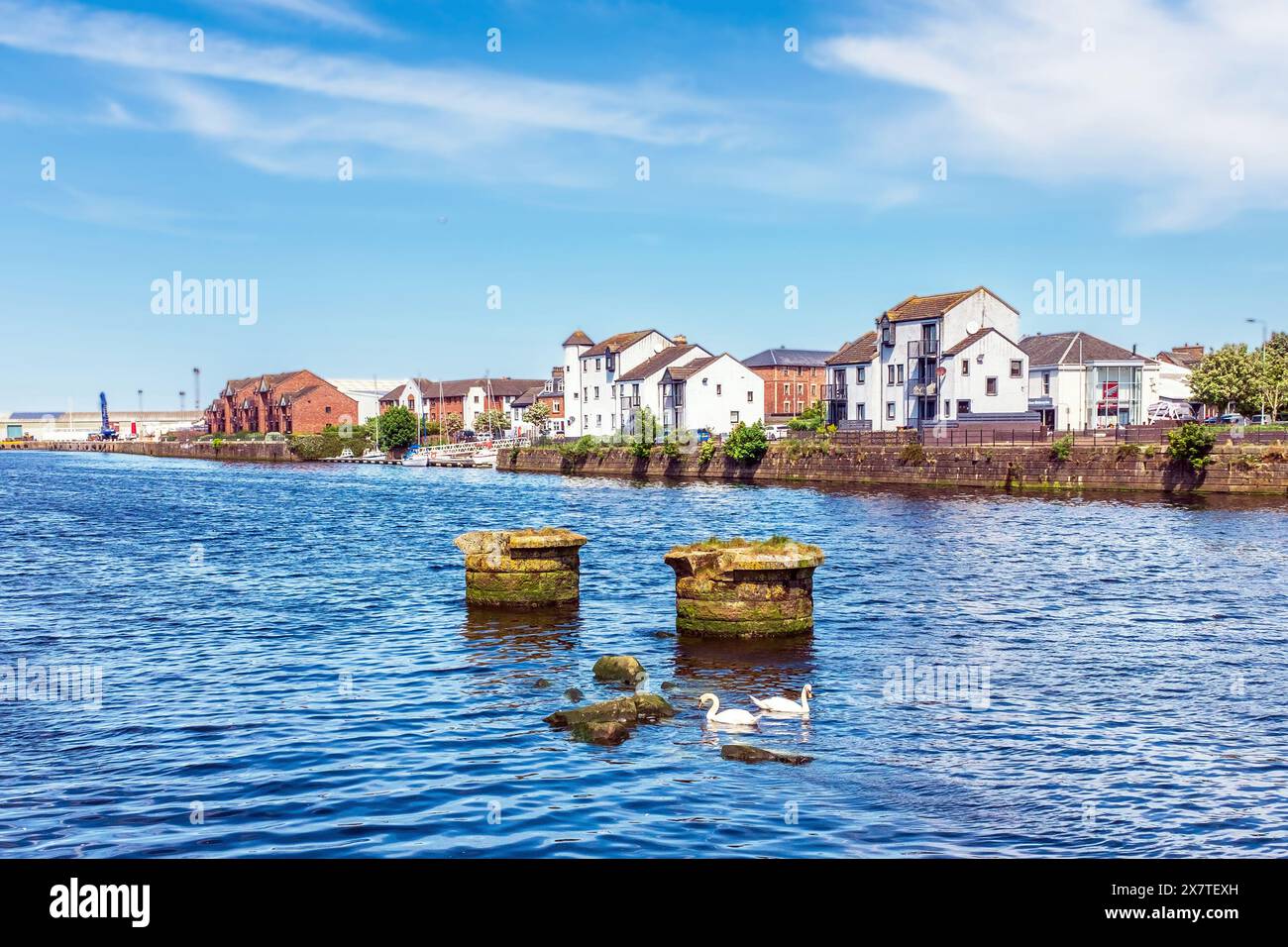 River Ayr, at Ayr harbour, with old bridge remains and new build houses ...