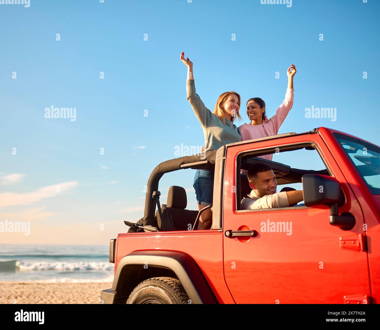 Couple With Friends On Vacation Driving Car On Road Trip Adventure To ...