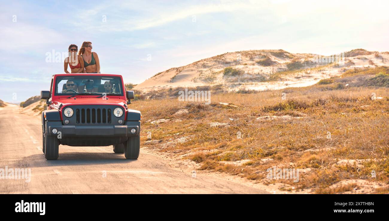 Couple With Friends On Vacation Driving Car On Road Trip Adventure To ...