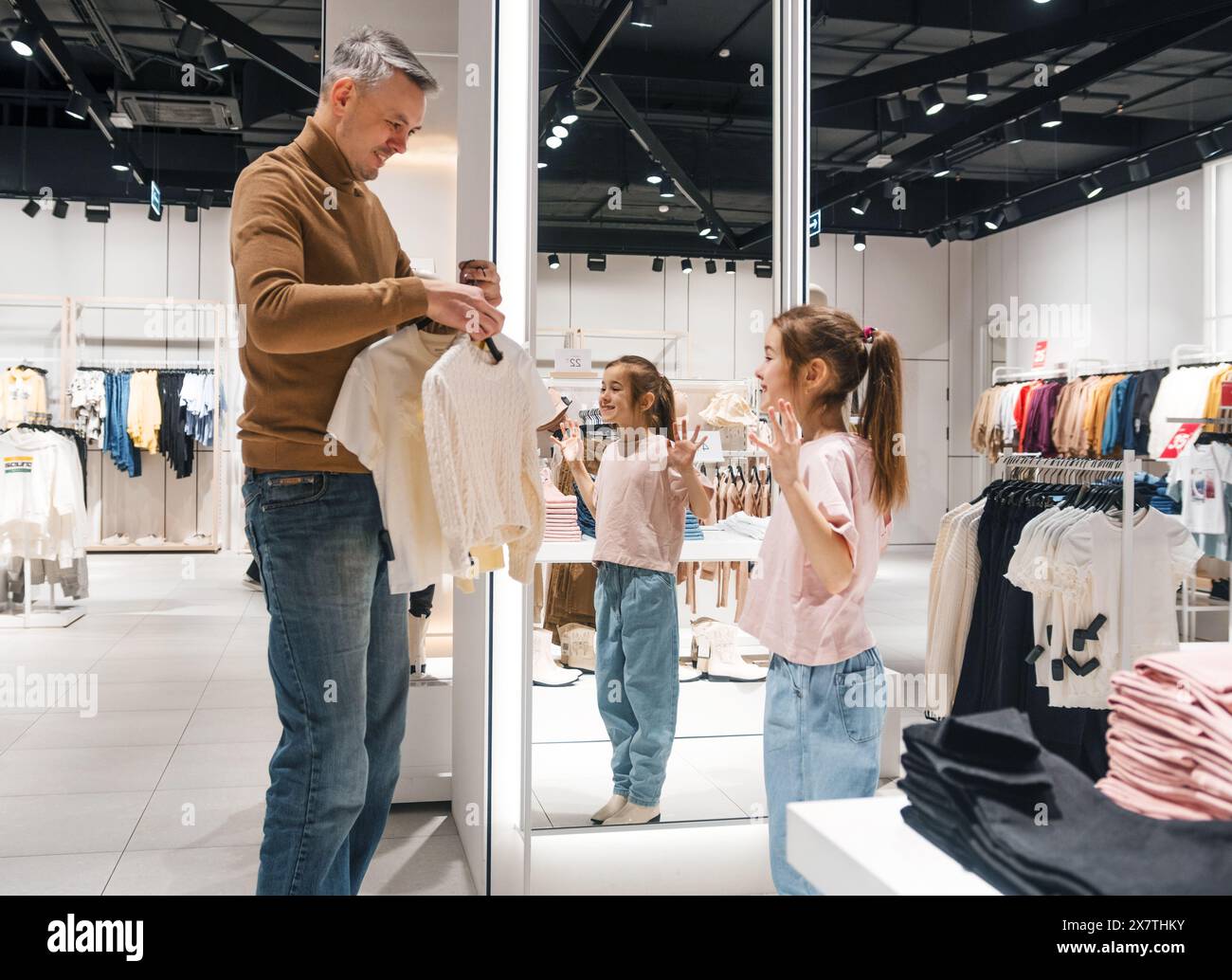 Father and Daughter Shopping for Clothes in a Store on a Weekend ...