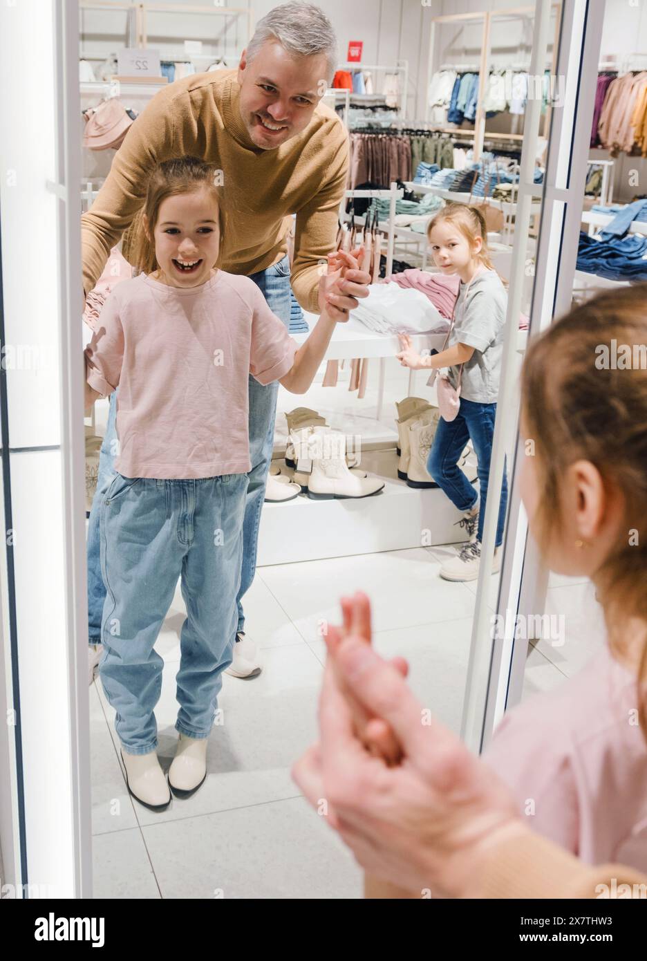 Father and Daughter Enjoy Shopping Together in a Clothing Store on a ...