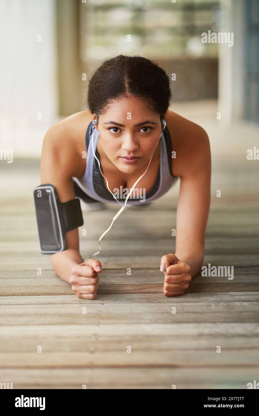 Earphones, plank or portrait of girl runner streaming music to start ...
