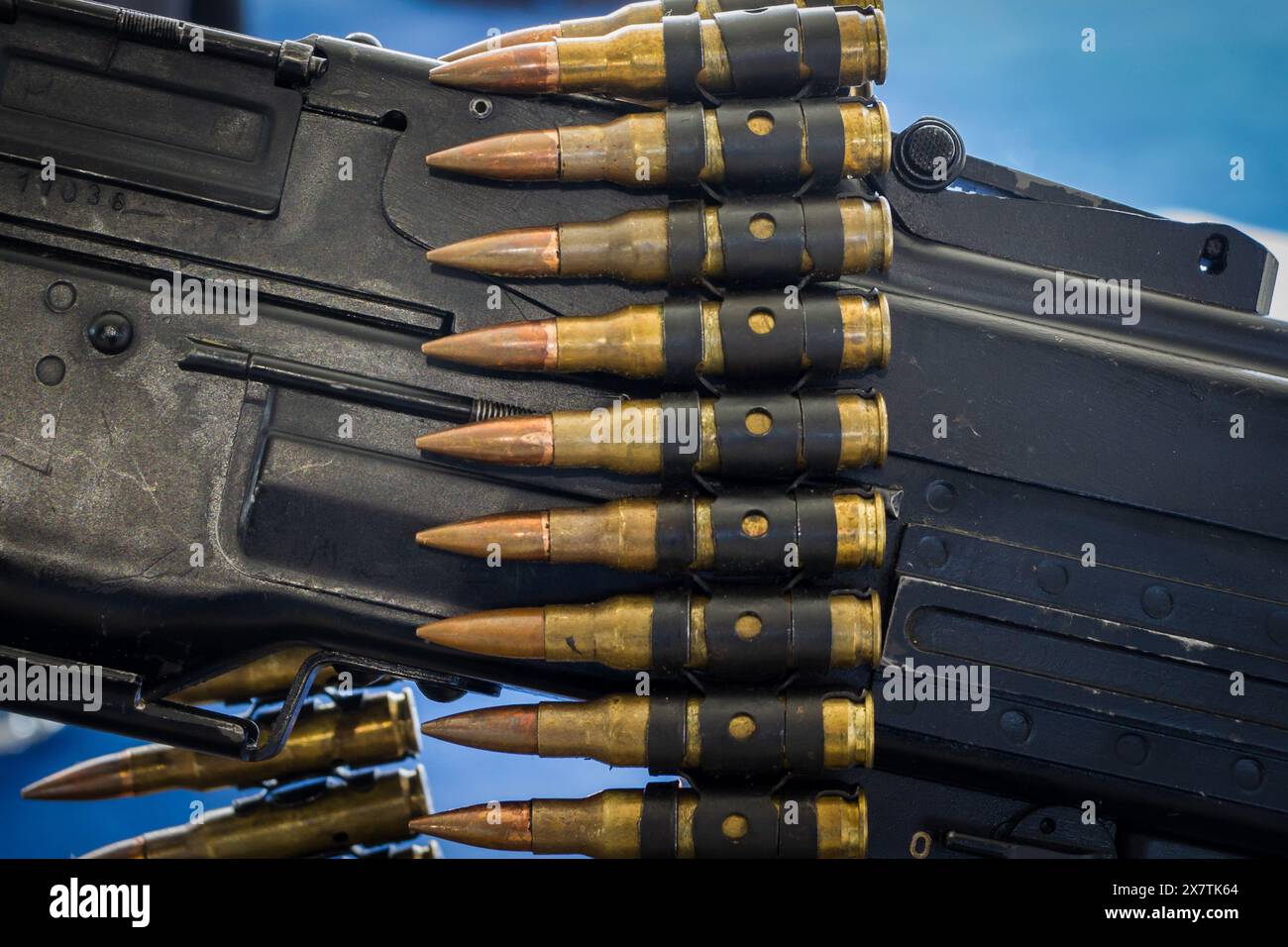 close up of bullets and gun with blue background Stock Photo - Alamy
